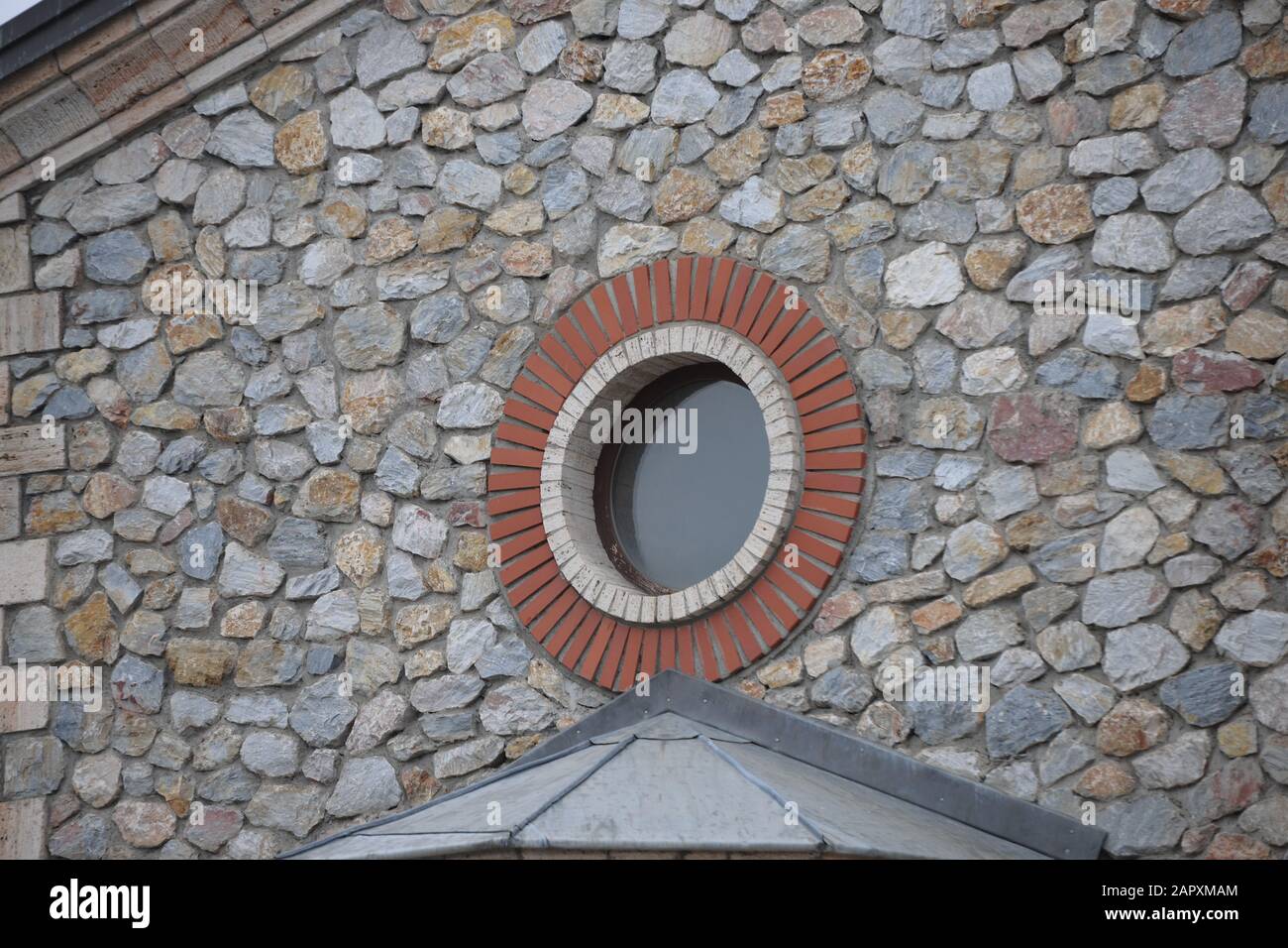 Round window on a stone wall of church. Round window in the historic ...