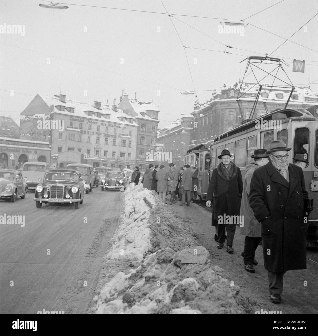 Visit to Munich Tram stop Karlsplatz in the snow with left a Mercedes ...