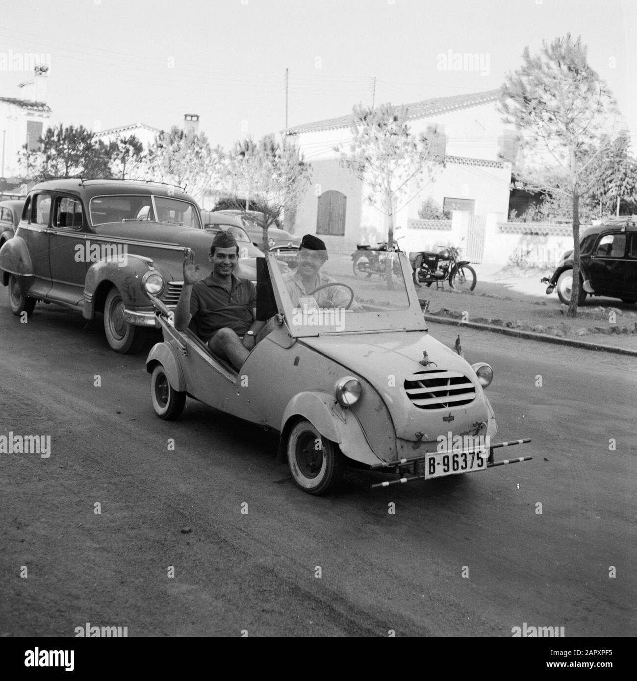 Old cars in Spain Two men driving in the repaired Voisin Date: 1958 ...