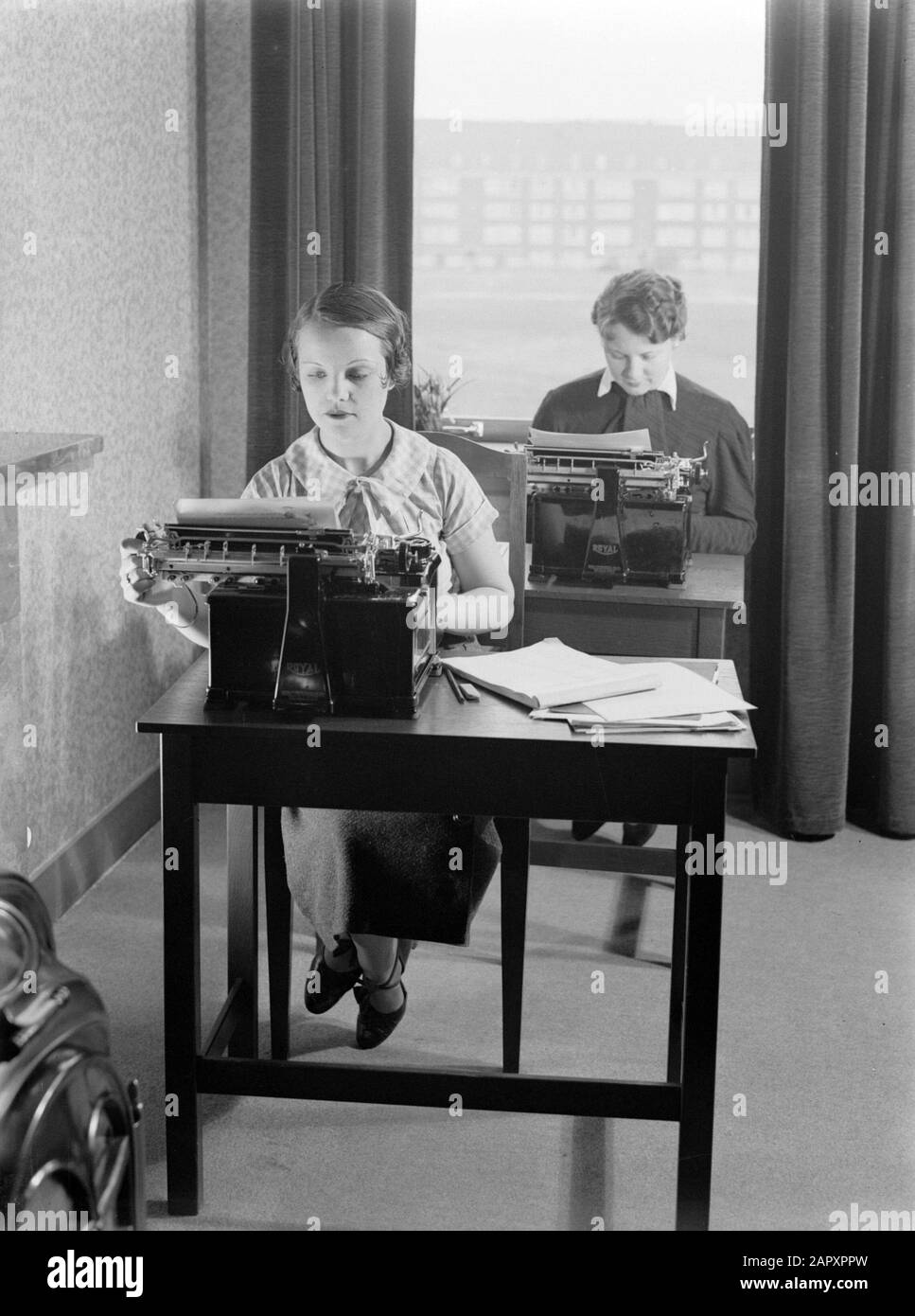 Two women behind typewriters Date: 1931 Keywords: typewriters, typistes ...