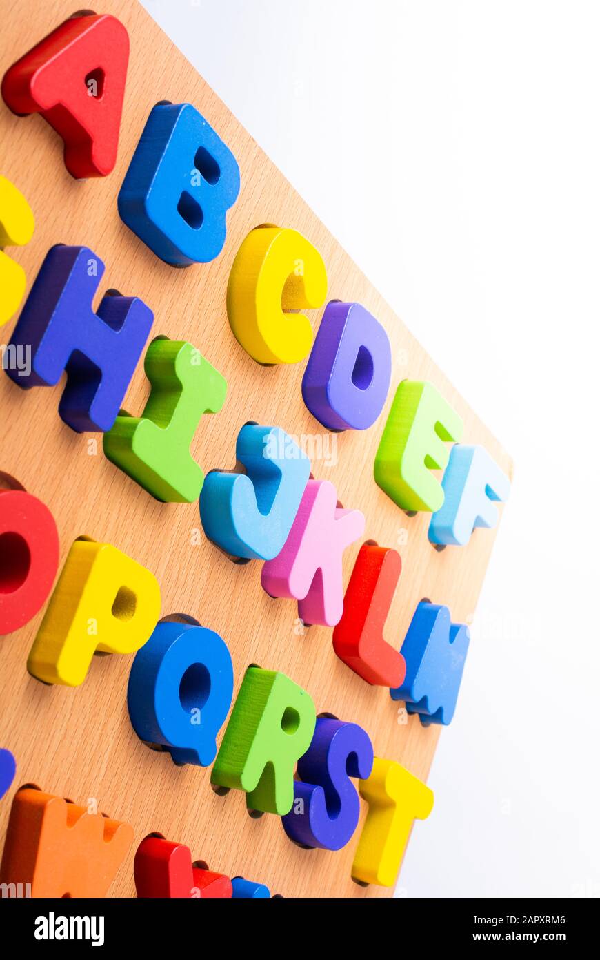 Colorful letter blocks on board on white background Stock Photo - Alamy
