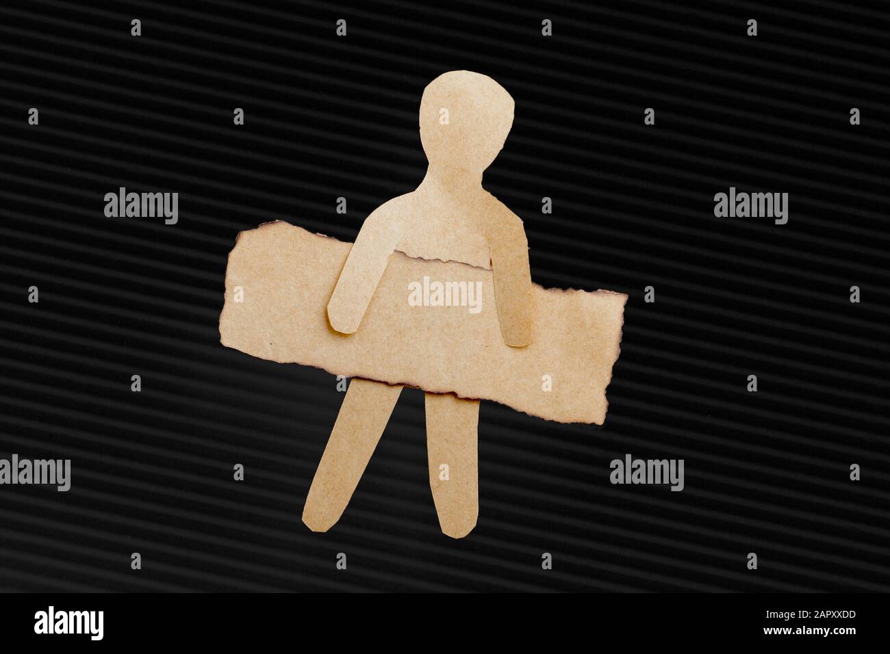 Paper man shape holding burnt note paper in hand Stock Photo - Alamy