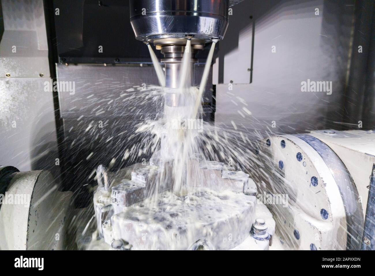 a process of industrial wet milling in 5-axis cnc machine with coolant ...