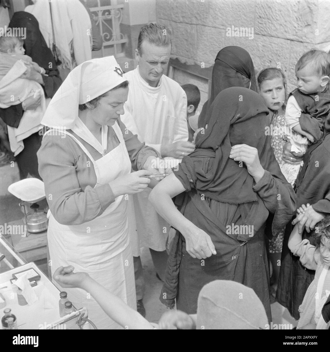 Israel 1948-1949 Adults and children in a polyclinic while a nurse of ...