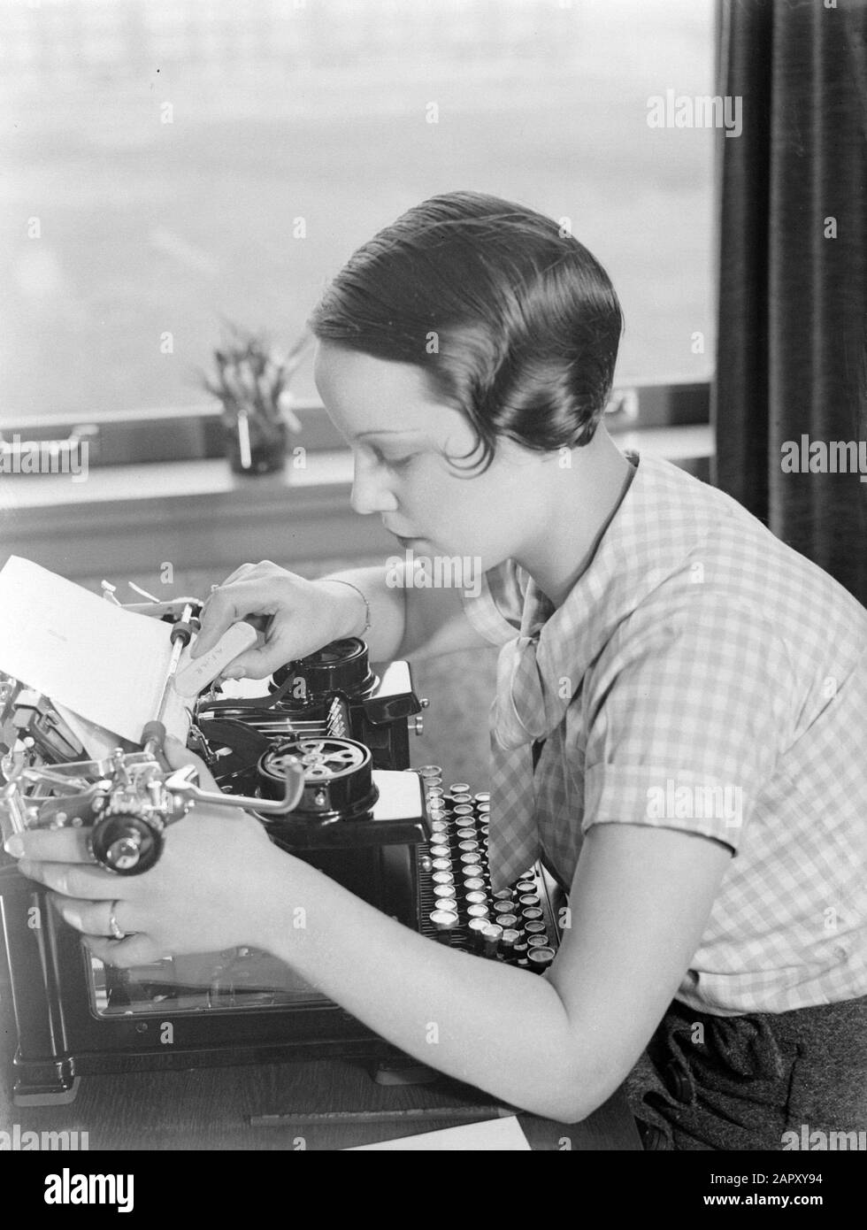 Woman behind a typewriter Date: 1931 Keywords: typewriters, typistes ...