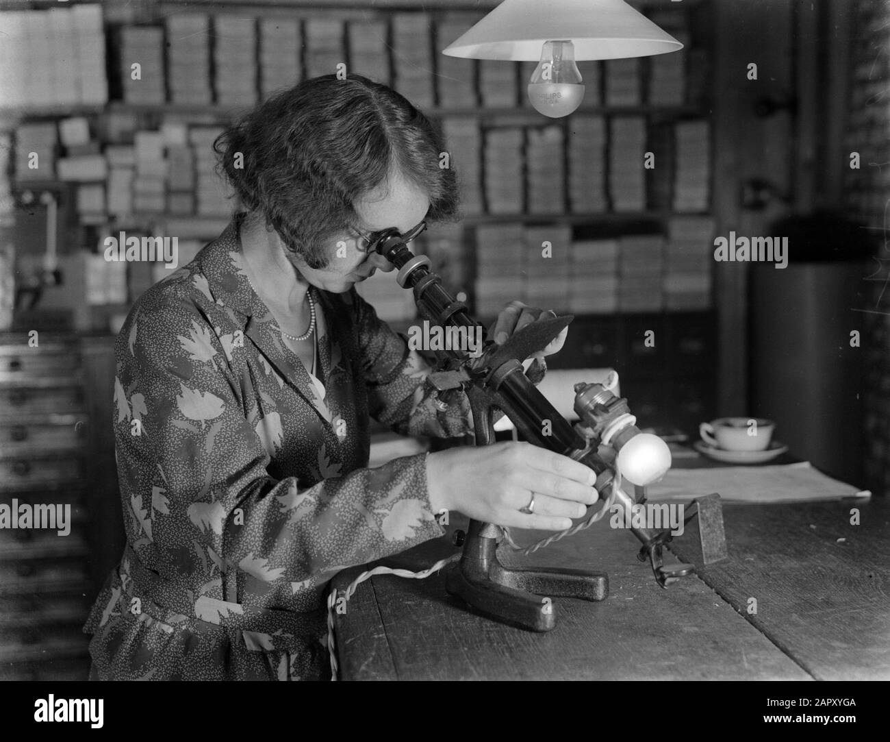 Manufacture of glasses Woman with a microscope Date: 1931 Keywords ...