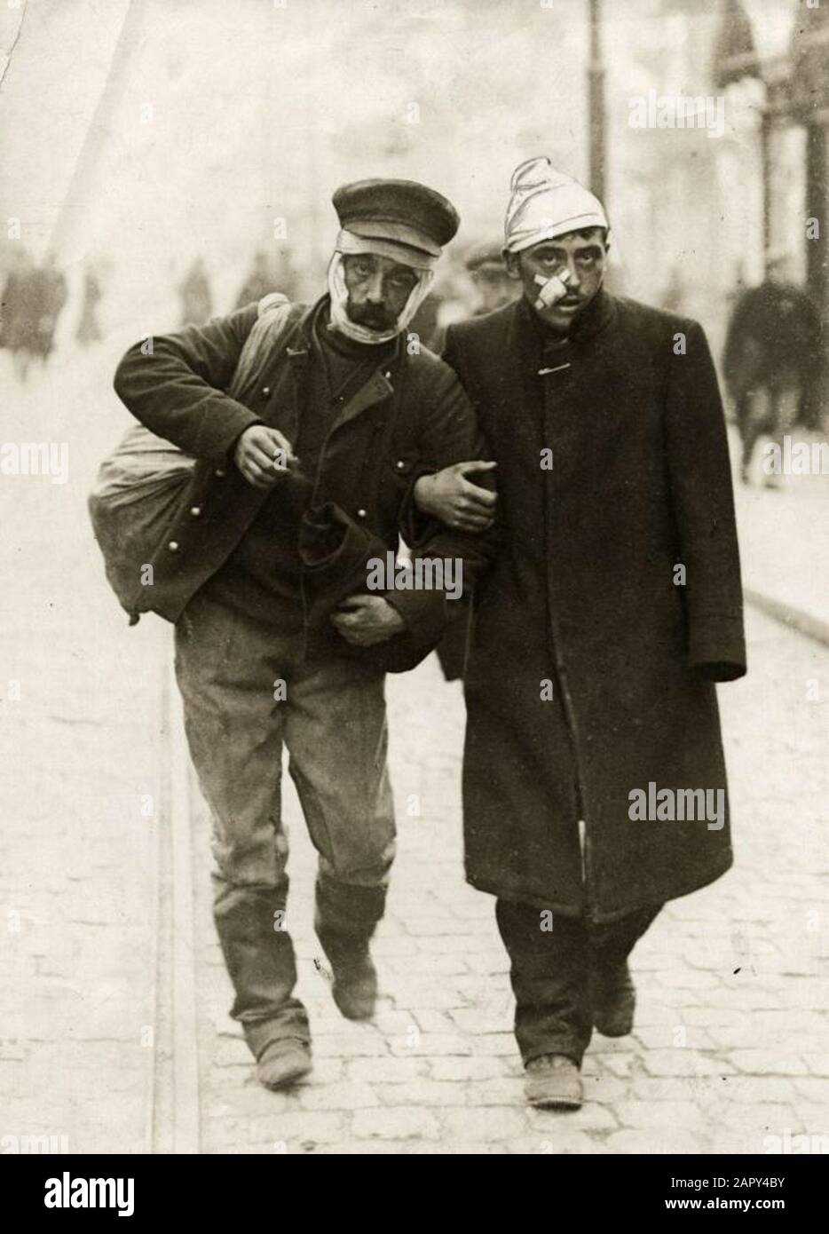 World War I. Two sad German and Belgian wounded soldiers walk on the ...
