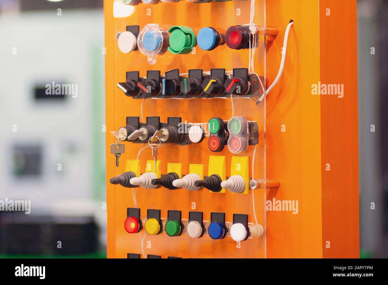 Multi-colored push button at the exhibition stand. Electric industry ...