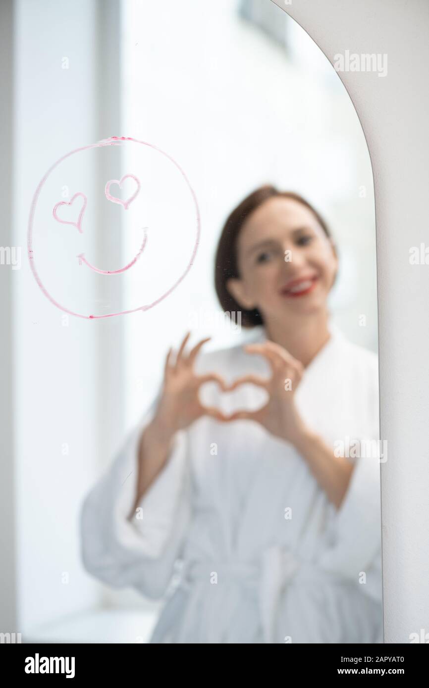 Amorous face with smile and heartshaped eyes and reflection of young ...