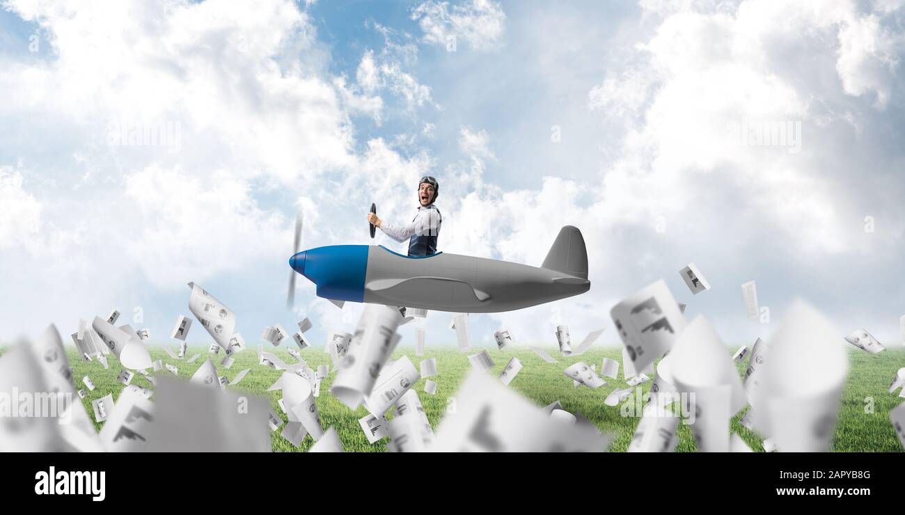 Businessman in aviator hat driving plane Stock Photo - Alamy