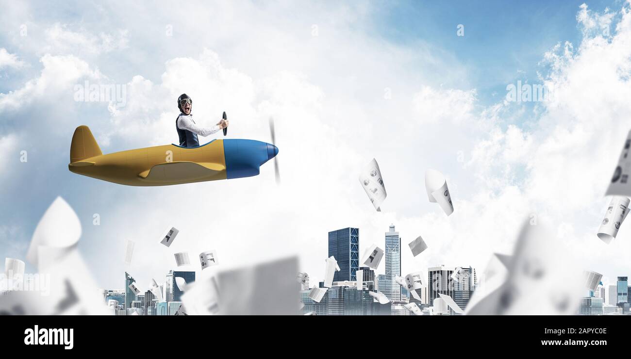 Businessman in aviator hat driving plane Stock Photo - Alamy