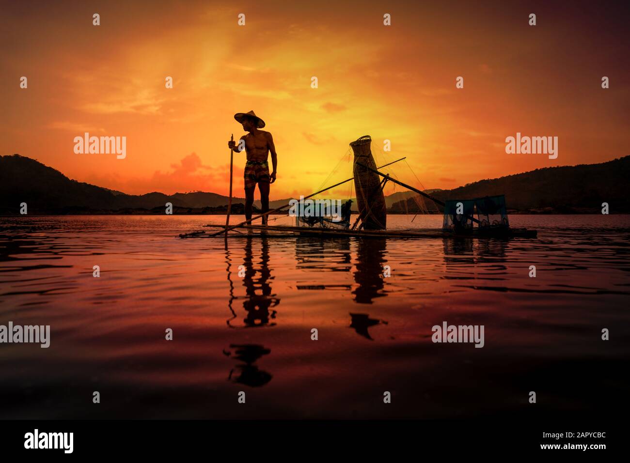 Fisherman in action when fishing in the lake Stock Photo - Alamy