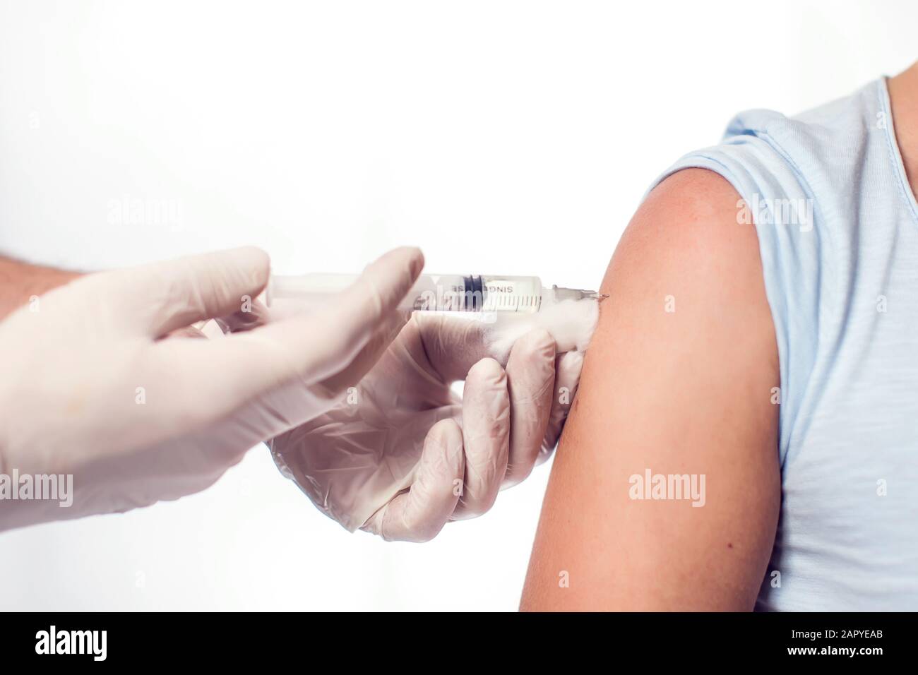 A doctor doing injection to the patient. Isolated. Close up shot ...