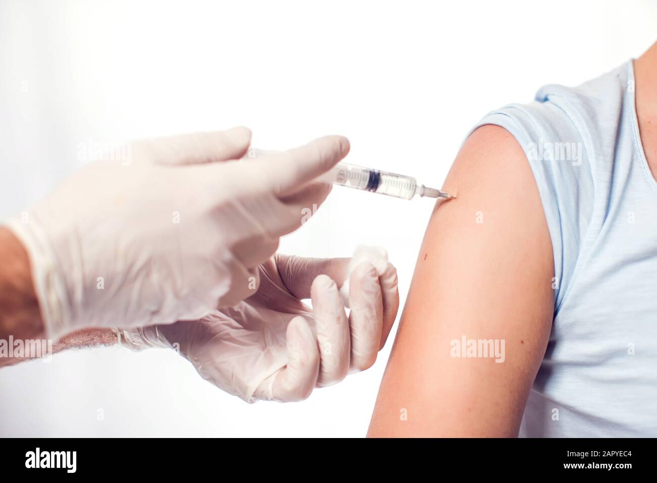 A doctor doing injection to the patient. Isolated. Close up shot ...