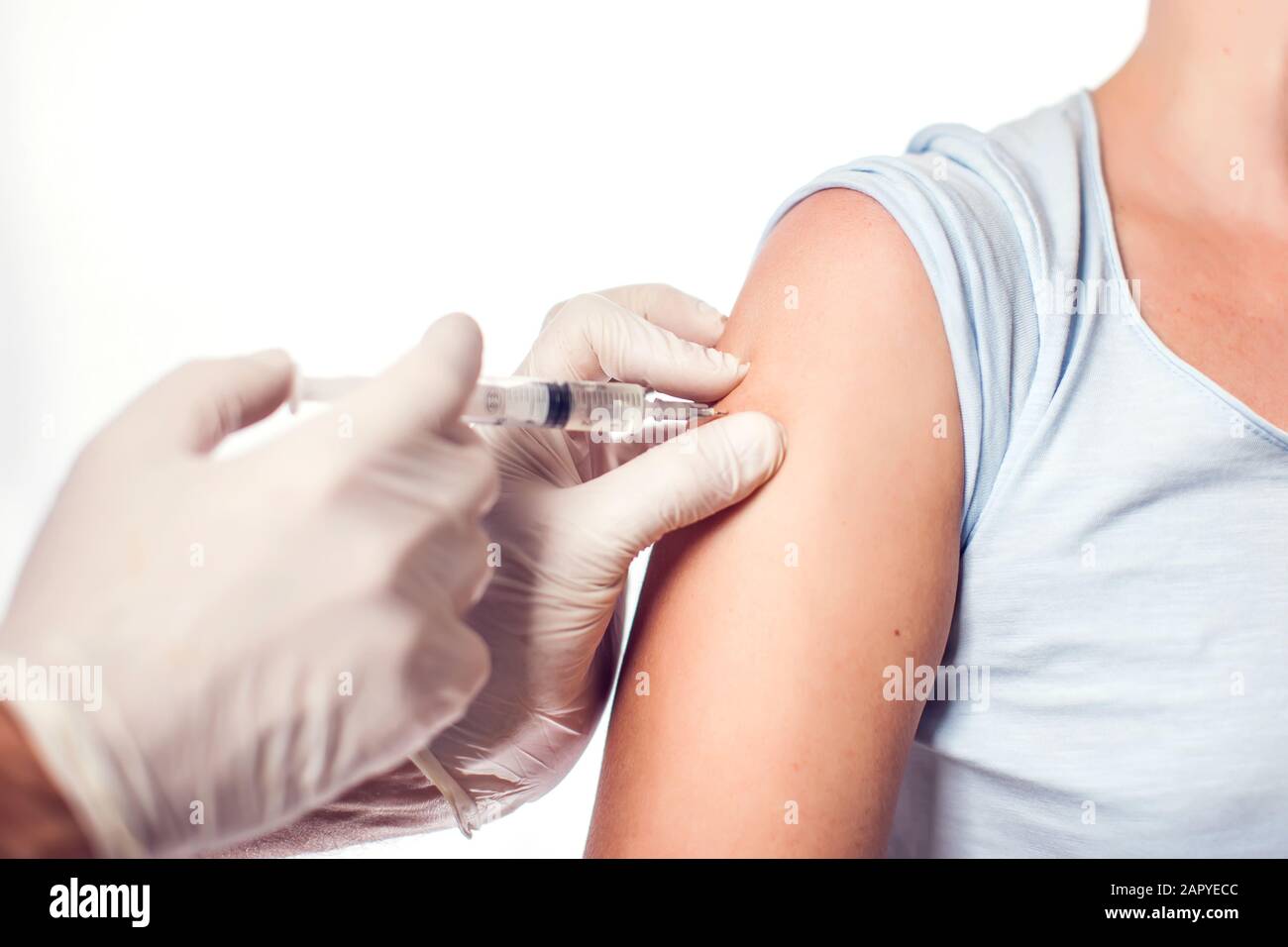 A doctor doing injection to the patient. Isolated. Close up shot ...