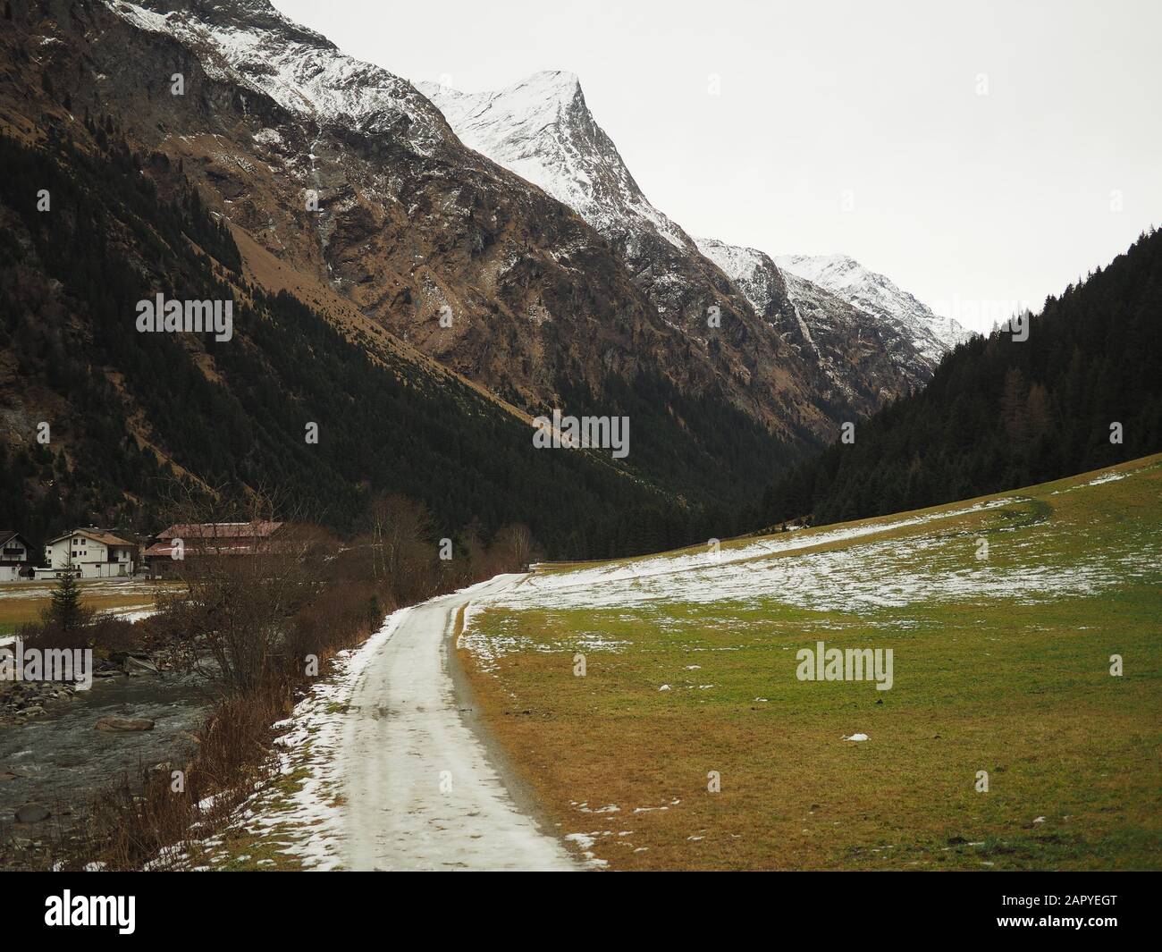 Landscape shot of a white pathway surrounded by high mountains Stock ...