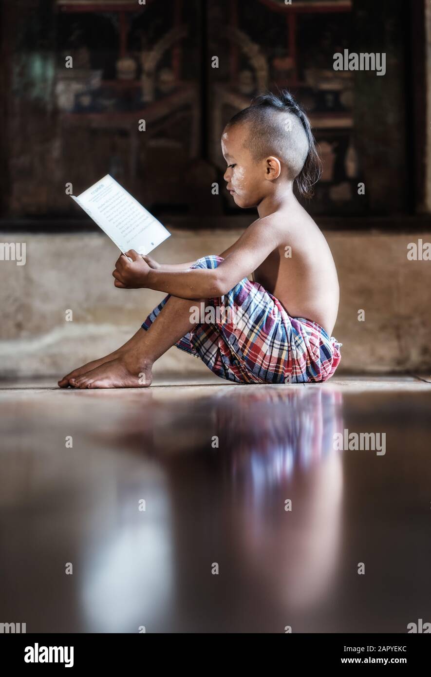 Asian boy reading book Stock Photo - Alamy
