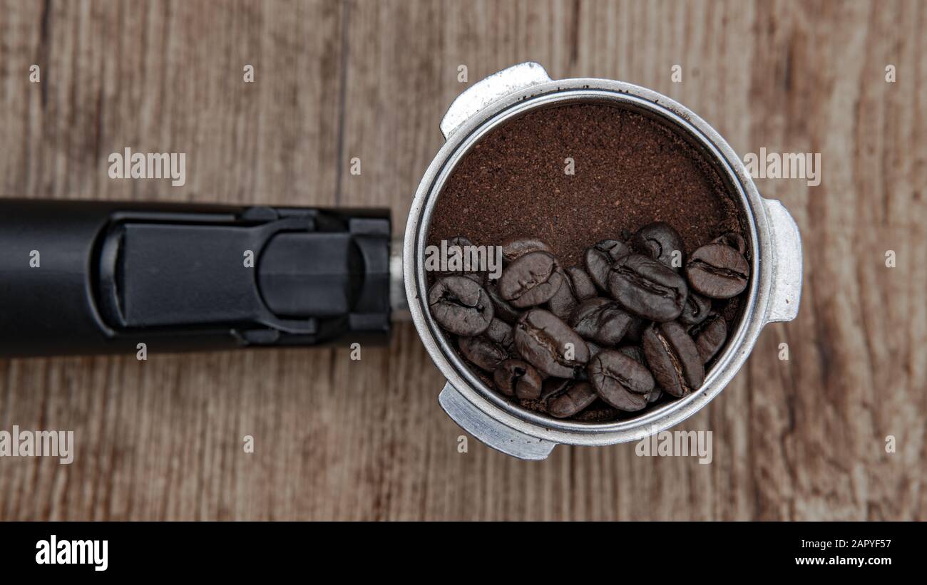 Overhead shot of coffee beans on a coffee powder Stock Photo - Alamy