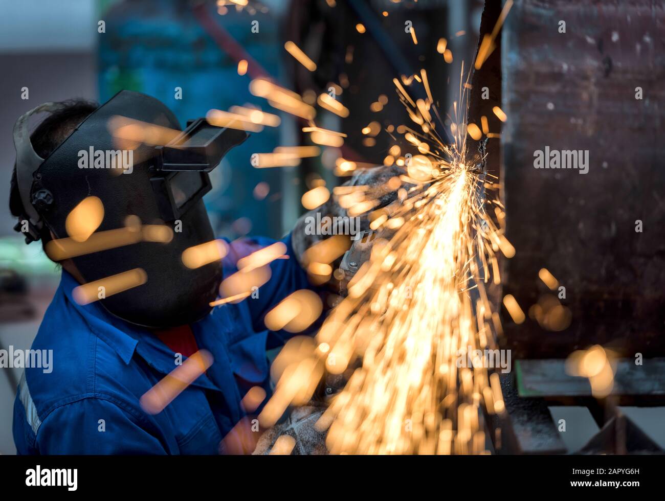 Electric wheel grinding on steel pipe in factory Stock Photo - Alamy