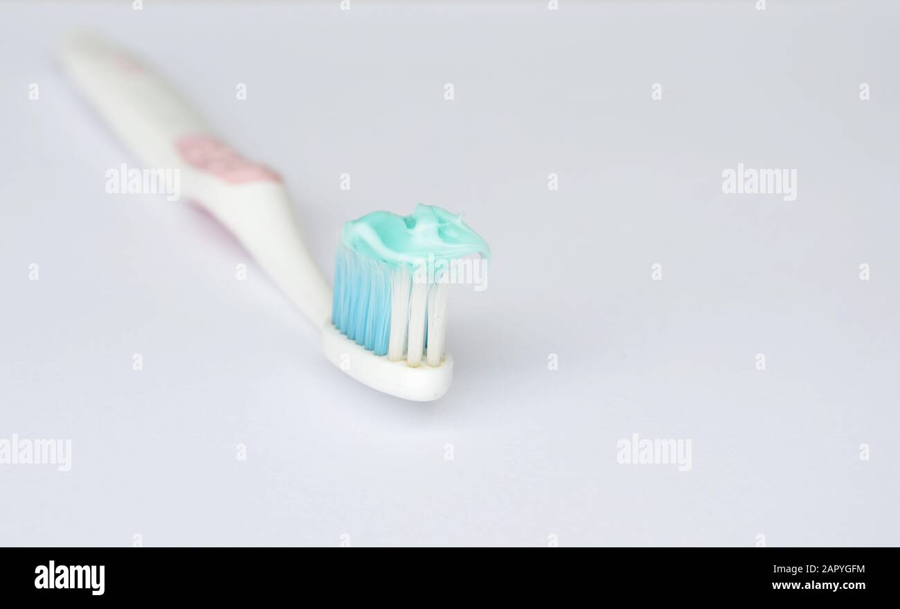 toothpaste put on toothbrush in white background Stock Photo - Alamy