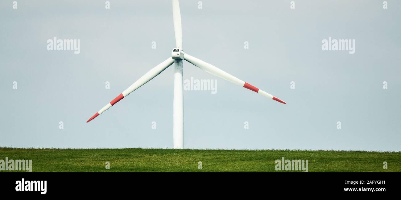 Wind fan standing on a green landscape during daytime Stock Photo - Alamy