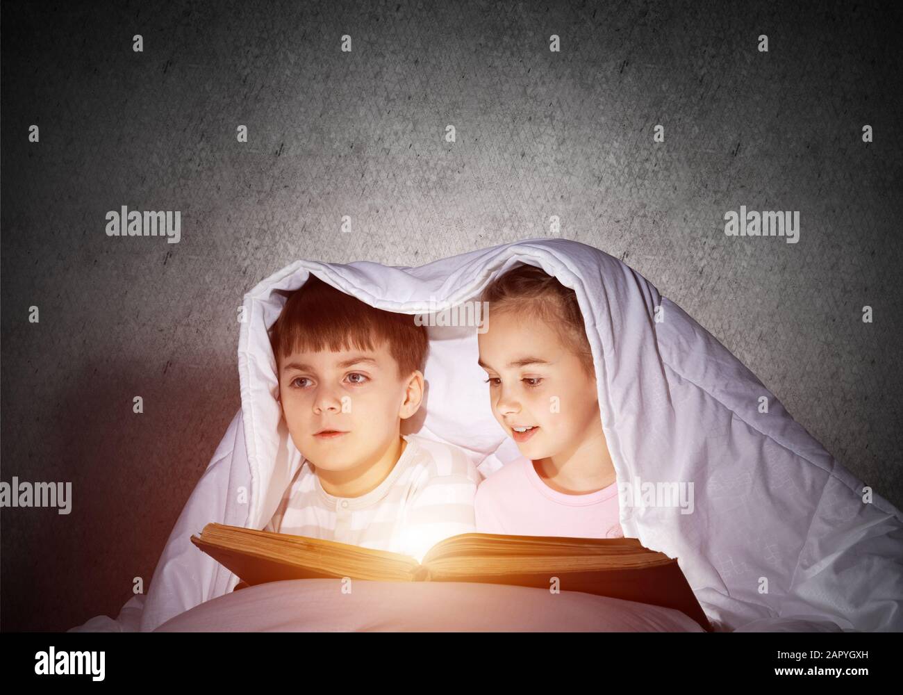 Happy children with flashlight hiding Stock Photo - Alamy