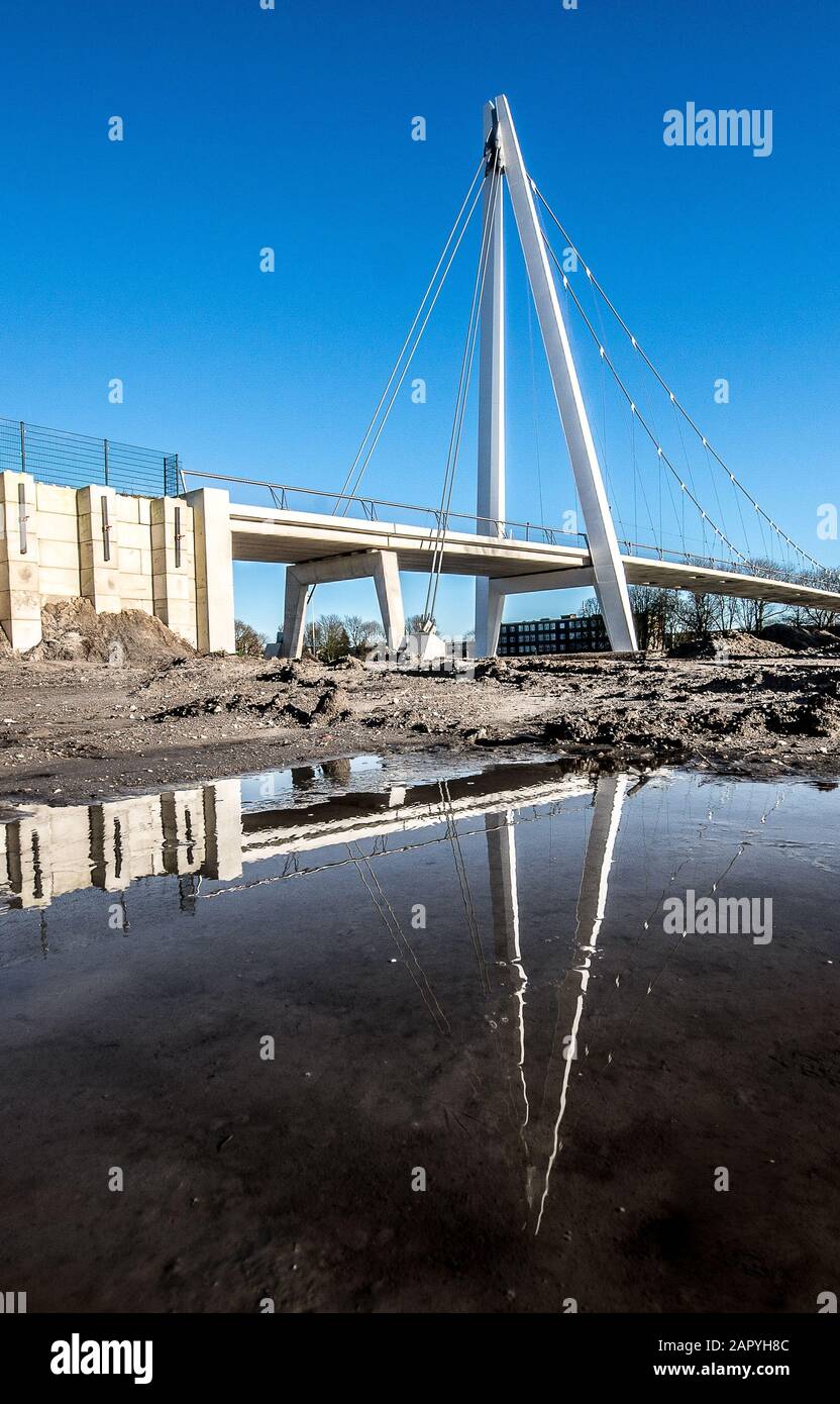 Low angle shot of a bridge standing over some water and soil under a ...