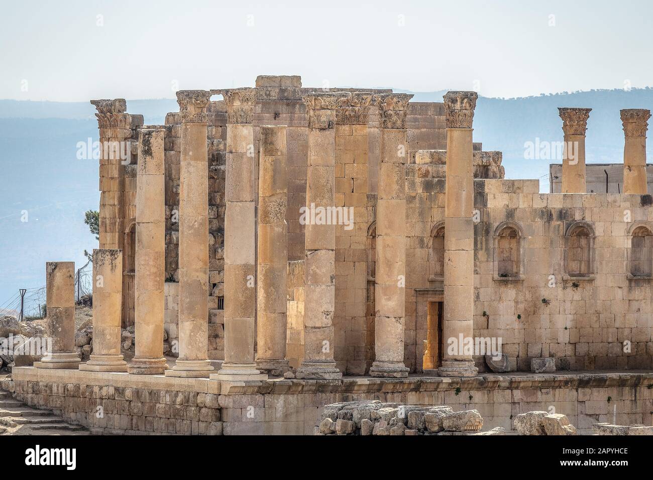 Ruined ancient building made of large towers and rocks under a clear ...