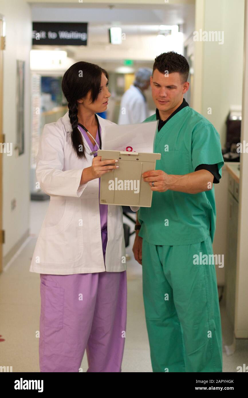 Vertical picture of doctors consulting with each other in a hospital ...