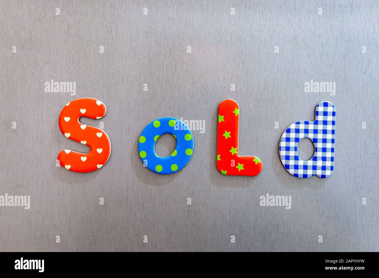 Word sold made of colorful magnetic letters on a brown background Stock ...