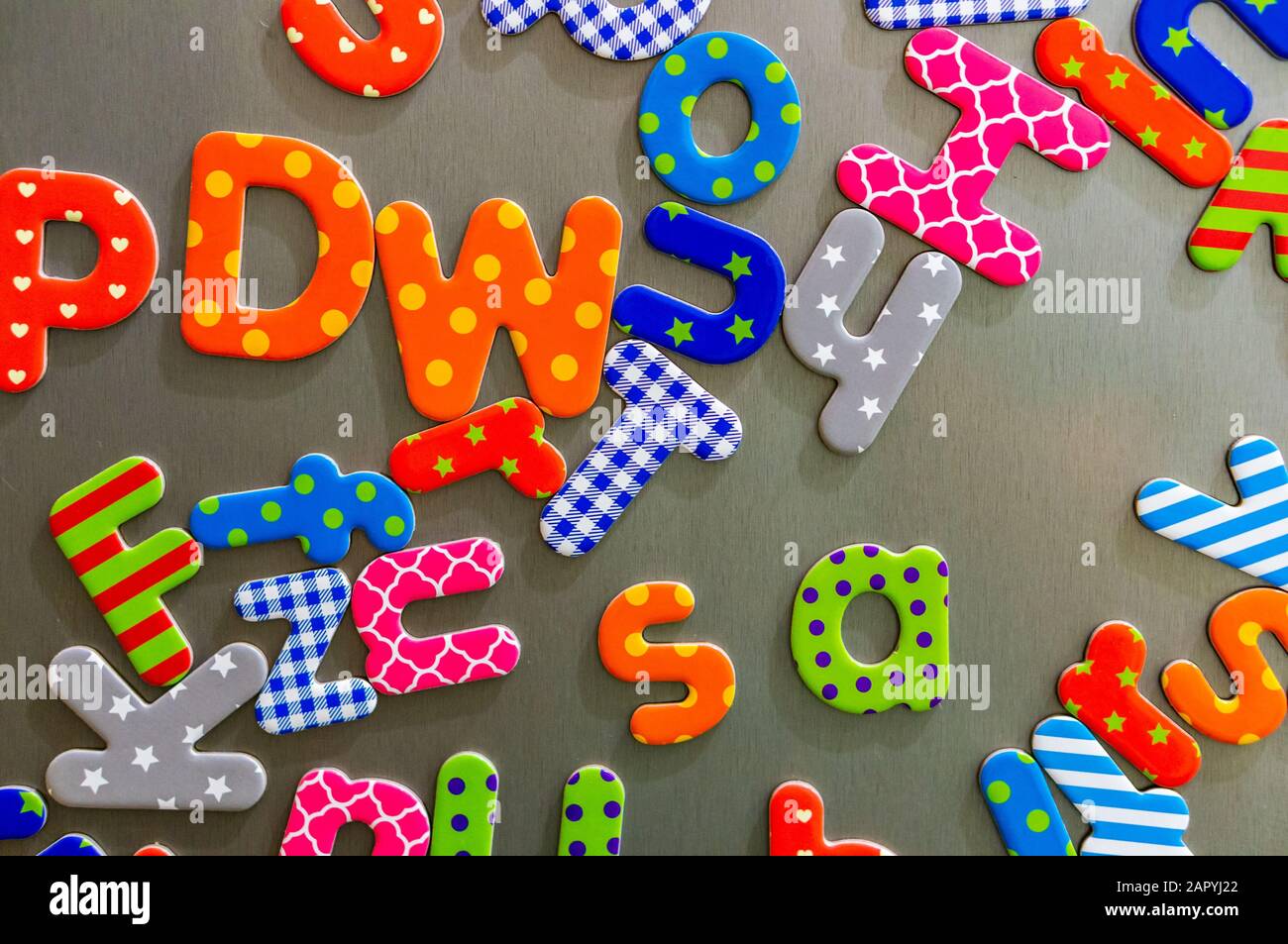Magnetic letters in a beige background Stock Photo - Alamy