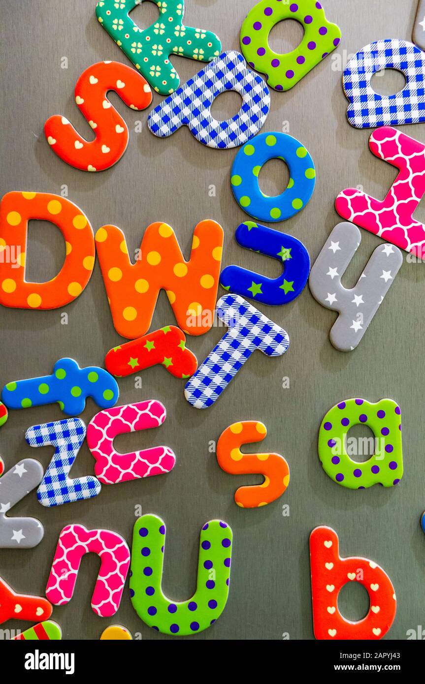 Magnetic letters in a beige background Stock Photo - Alamy