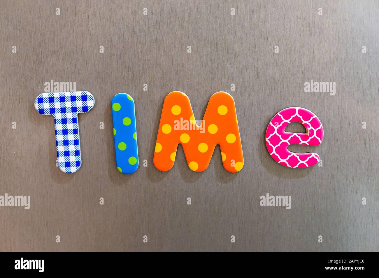 Closeup shot of colorful words spelling out time Stock Photo - Alamy