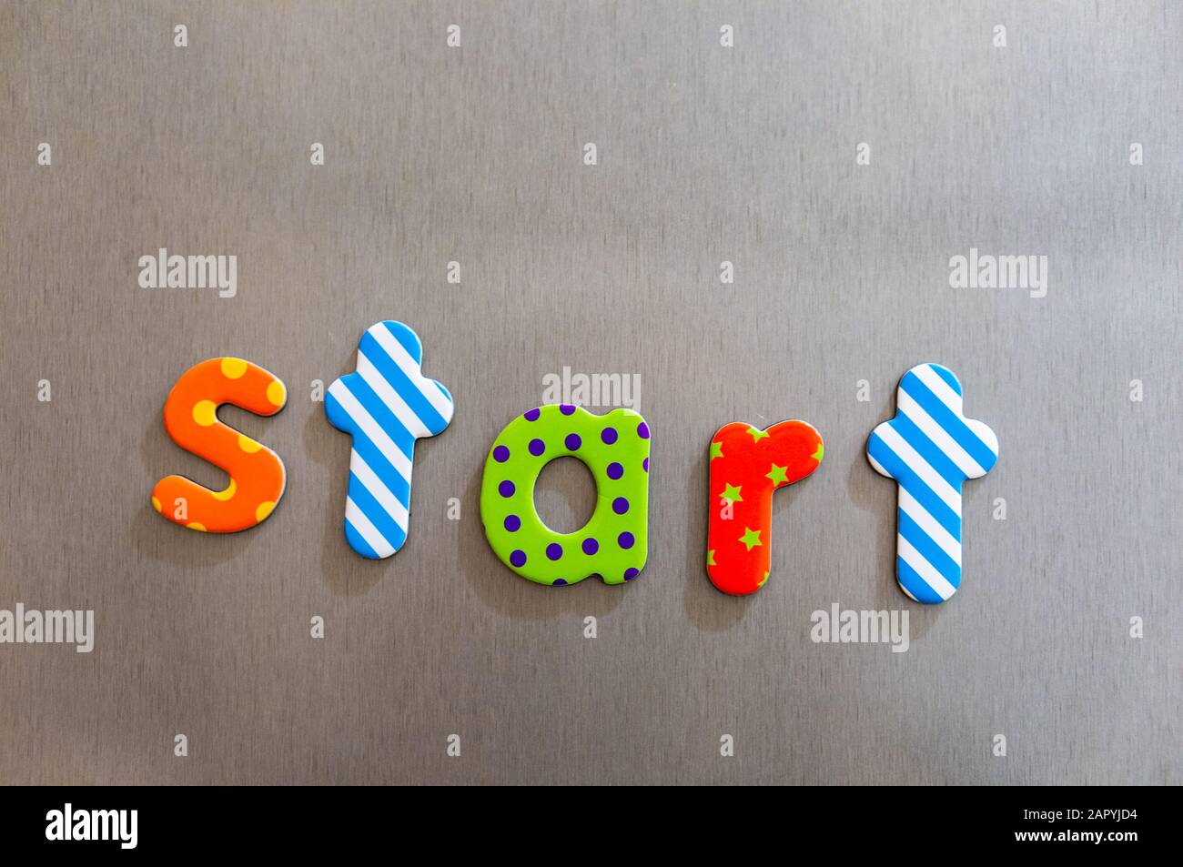 Closeup shot of colorful words spelling out start Stock Photo - Alamy