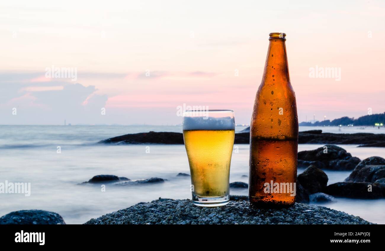 Glass of beer with sea background Stock Photo - Alamy