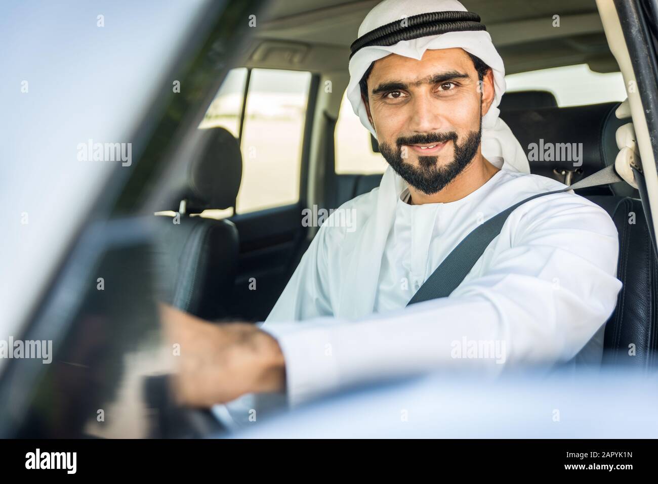 Handsome arabic man driving a car Stock Photo - Alamy