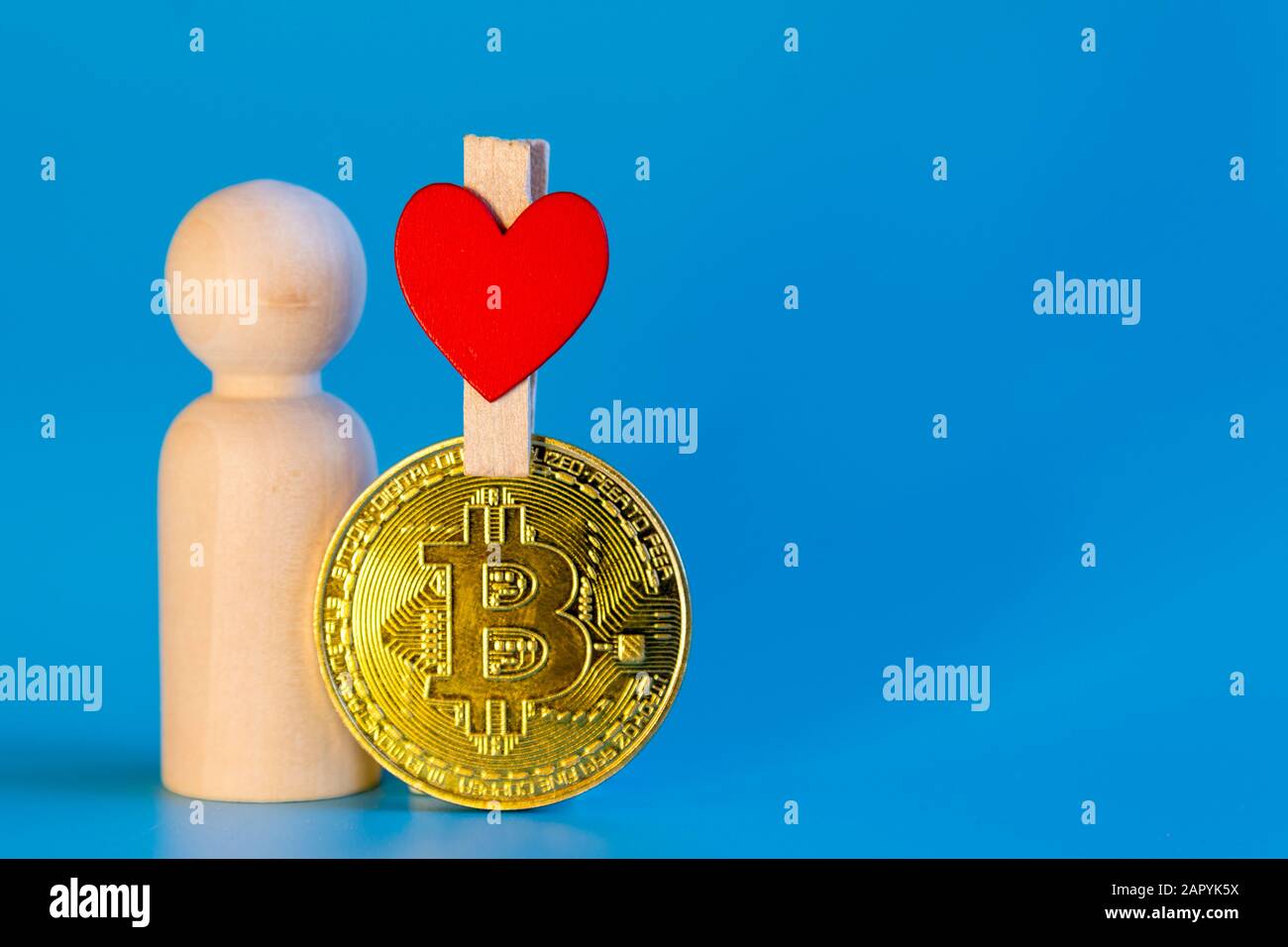 Human figurine, bitcoin coin and heart on a blue background. love for ...