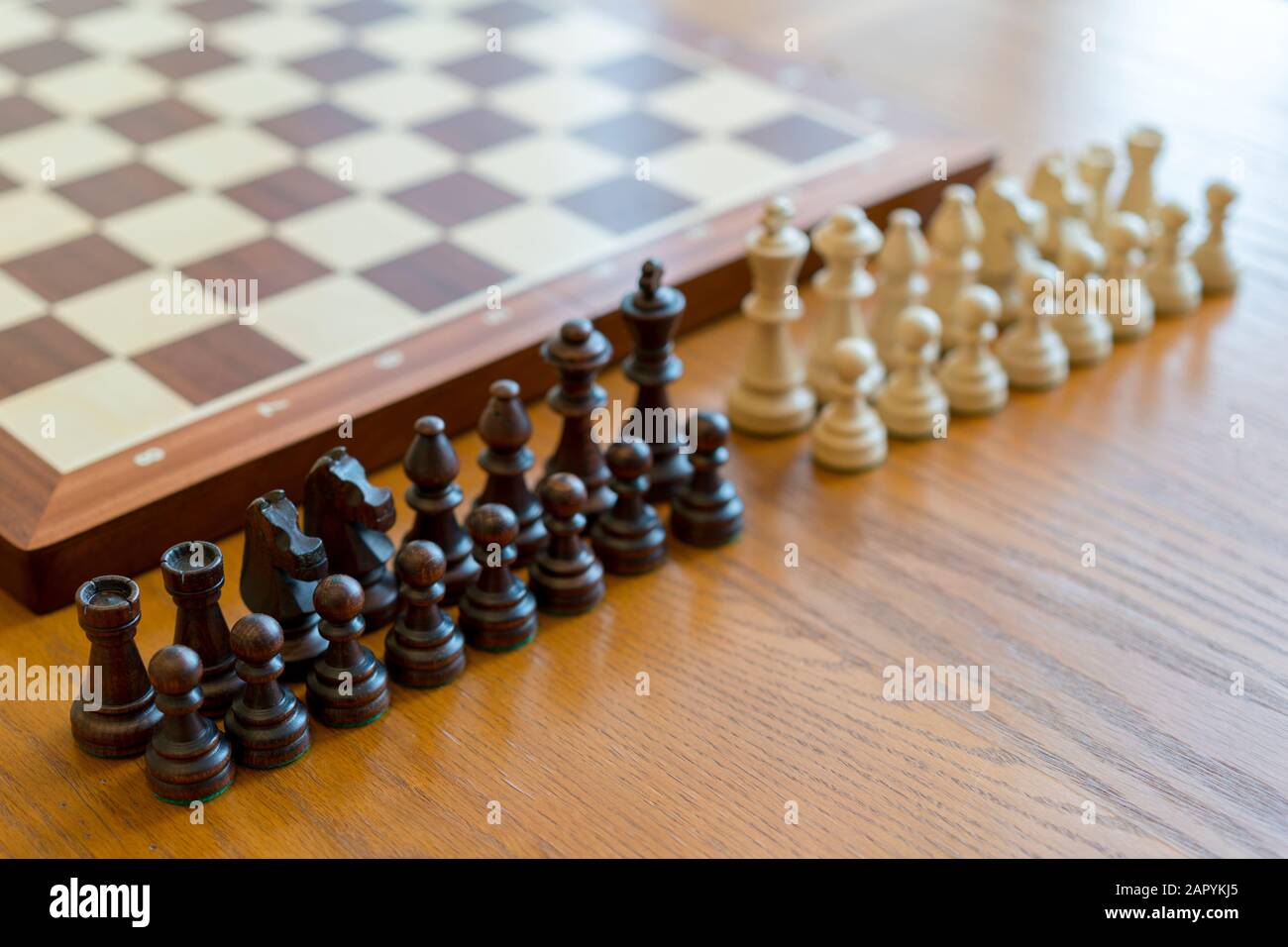 Chess pieces in front of a chessboard Stock Photo - Alamy