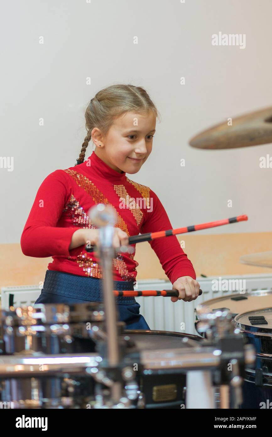 Teen girl playing the drums. Teen girls are having fun playing drum ...
