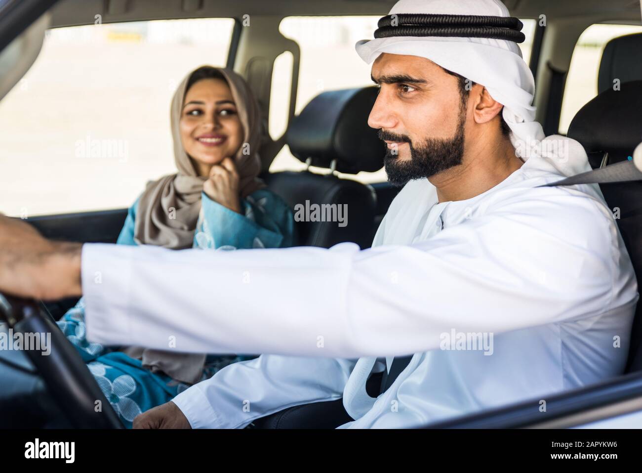 Beautiful middle eastern couple driving a car Stock Photo - Alamy