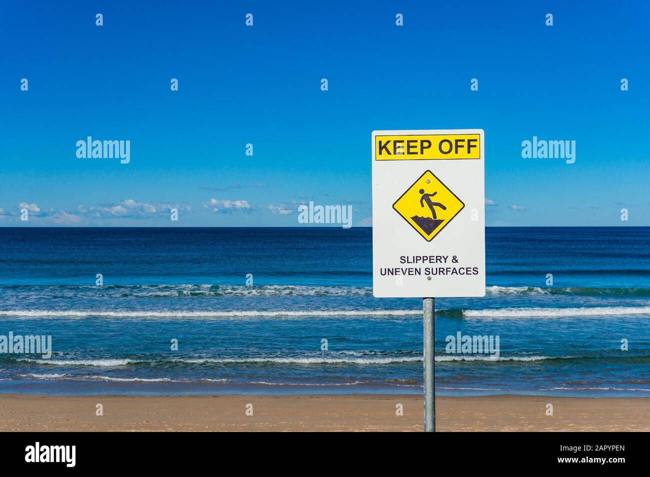 Keep out warning beach sign against ocean and blue sky on the ...