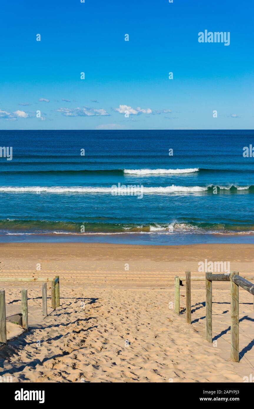 Beach entrance with wooden railings and beautiful ocean beach view ...