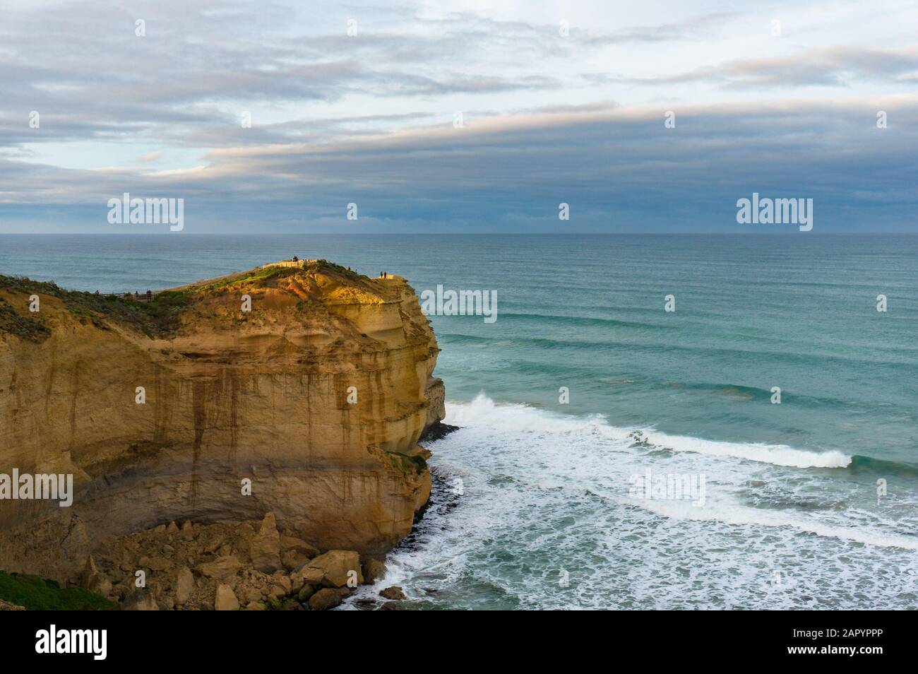 High cliff with observation deck, lookout platform against vast ocean ...