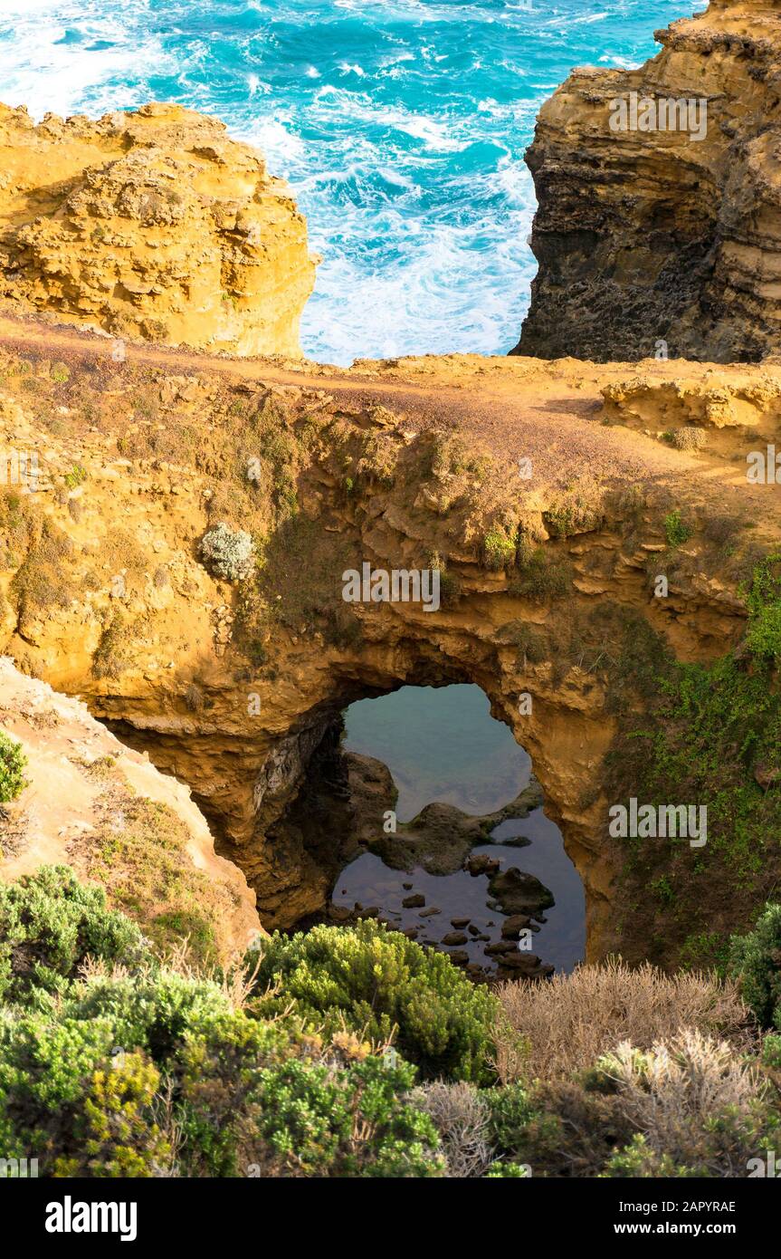 Beautiful stone arch in rock coastline with ocean view. The Grotto ...