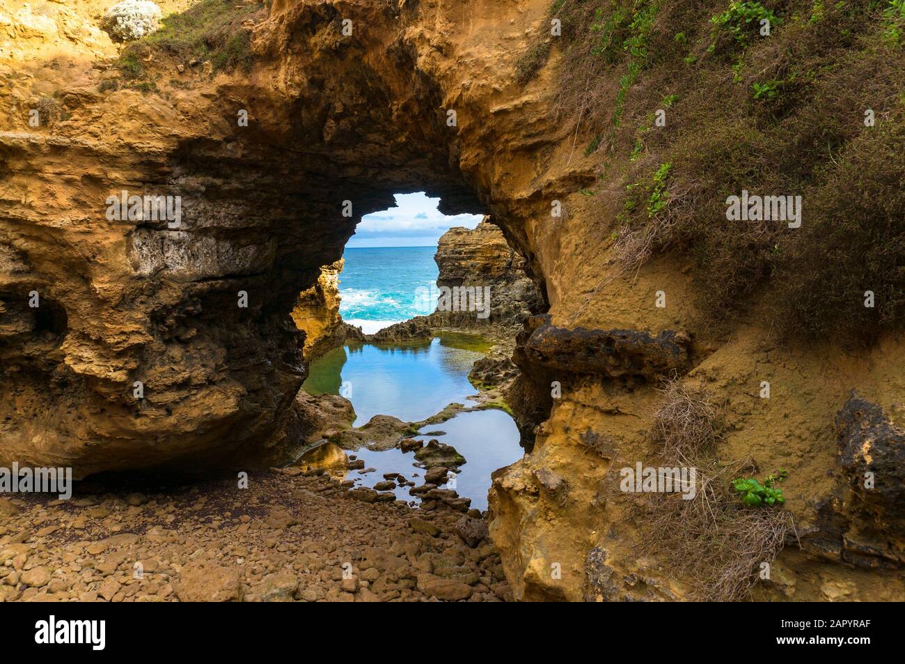 Natural rock formation with view of ocean on sunny day. The Grotto ...