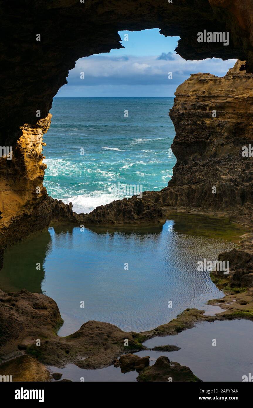 Picturesque ocean landscape of rock formation in from of arch with view ...