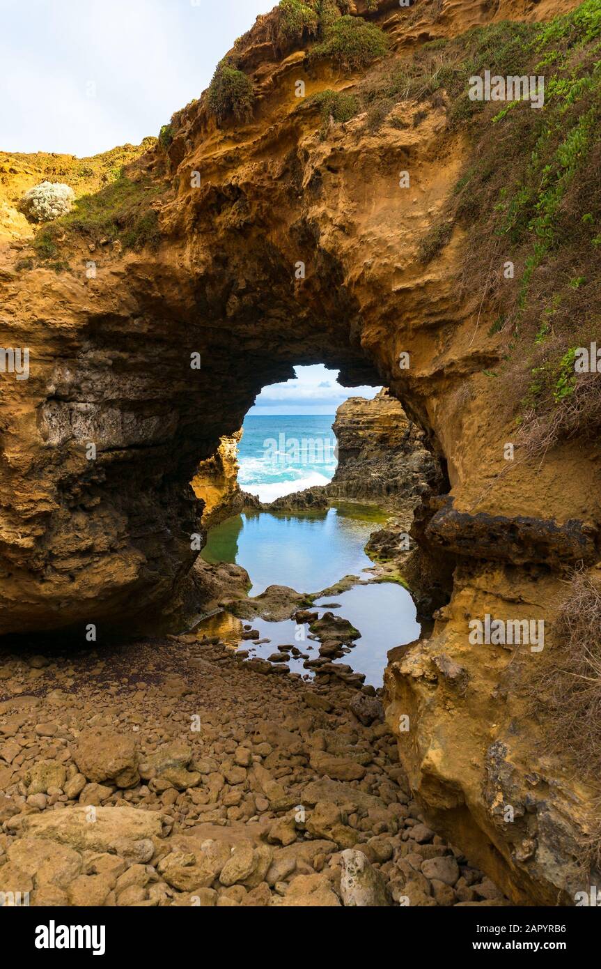 Beautiful rock formation in from of arch with view of blue ocean on ...