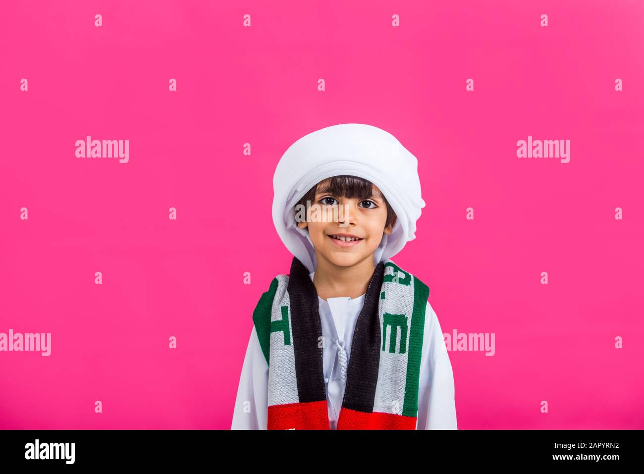 Middle eastern family with traditional emirates dresses posing in a ...