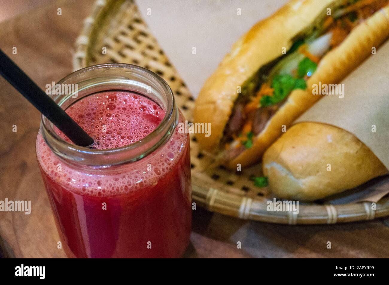 Traditional Vietnamese Banh Mi sandwich with red fruit smoothie drink ...