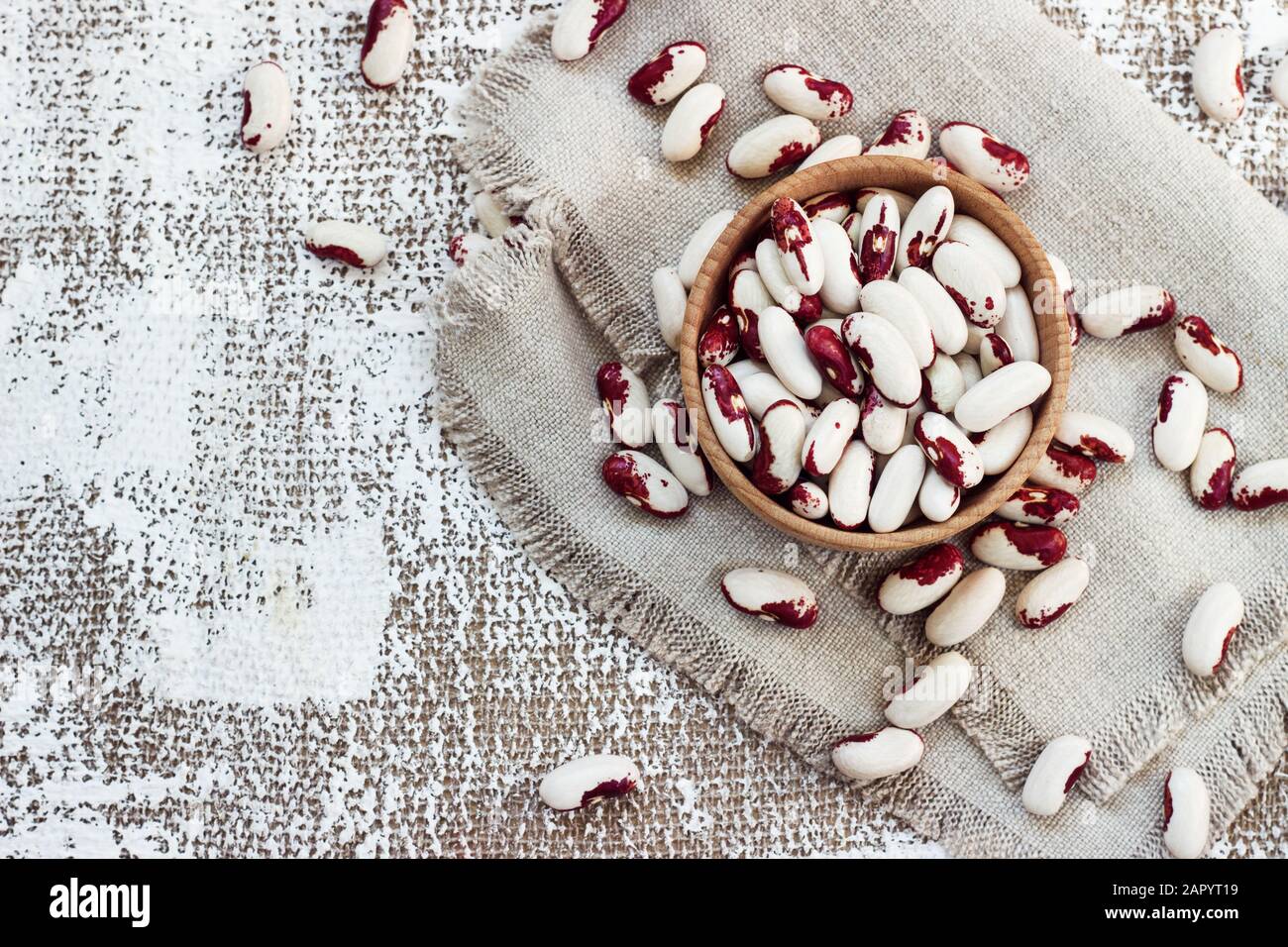 white-pink beans in a wooden cup on a light background Stock Photo - Alamy